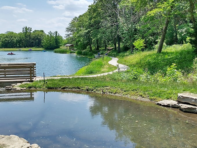 Tranquility perfected: Jenny Newman Lake's glassy surface mirrors Nebraska's blue skies while a winding path invites you to wander and wonder.