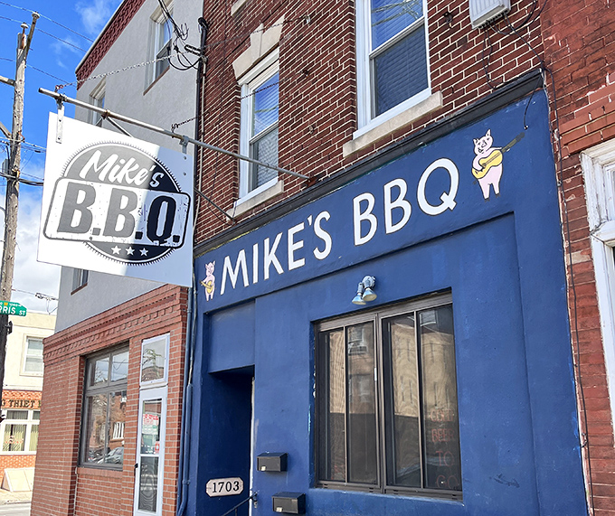 A closer look at Mike's BBQ's vibrant blue exterior and playful pig logo &ndash; a siren call to barbecue enthusiasts throughout South Philadelphia.