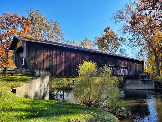 Like a wooden sentinel standing guard over the Ashtabula River, this historic bridge has weathered Ohio's seasons for generations with quiet dignity.