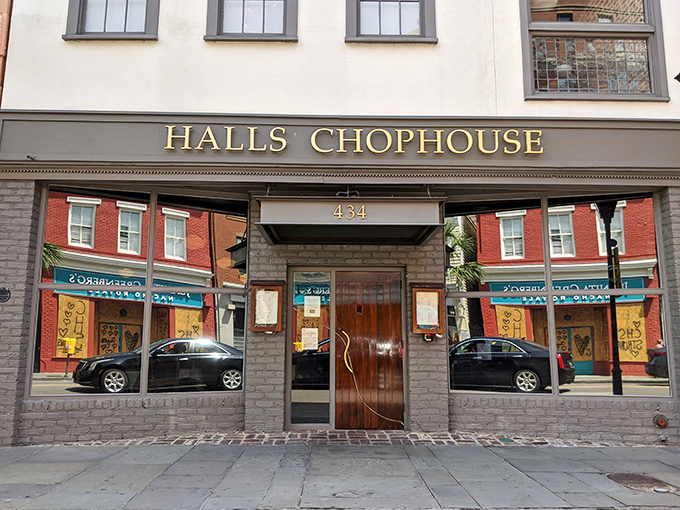 The golden lettering of Halls Chophouse gleams against the white facade like a beacon for carnivores on Charleston's historic King Street.