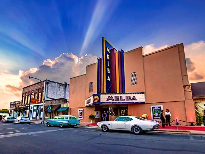 The Melba Theater stands like a time capsule on Batesville's Main Street, its neon glow promising affordable entertainment and community connection.
