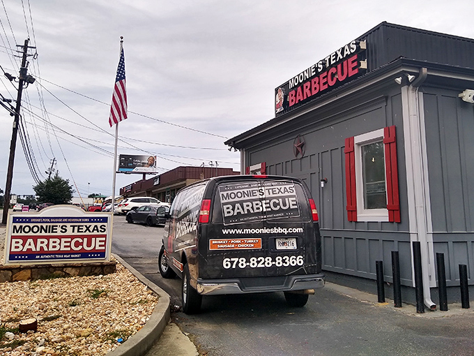The unassuming gray exterior with bold red signage is like a secret handshake &ndash; those who know, know. BBQ paradise awaits inside.