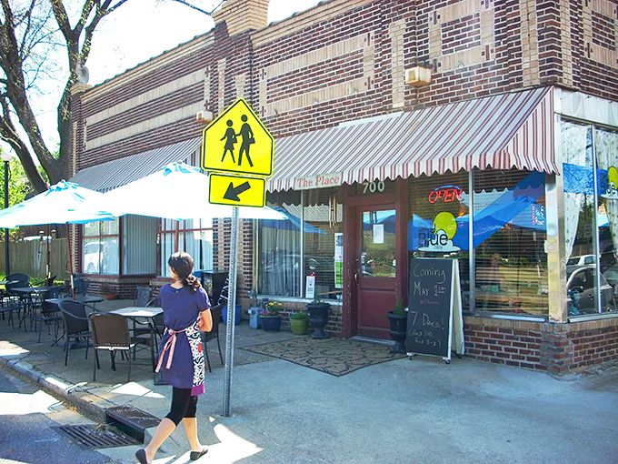 Morning sunshine bathes the cafe's charming exterior, where outdoor seating offers the perfect perch for people-watching between bites.