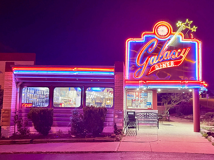 The neon glow of Galaxy Diner against the twilight sky isn't just signage&mdash;it's a beacon of breakfast hope on Route 66.