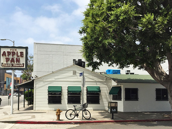 The unassuming white exterior of The Apple Pan stands like a time capsule on West Pico Boulevard, its vintage sign promising "Quality Forever" – a promise it keeps.
