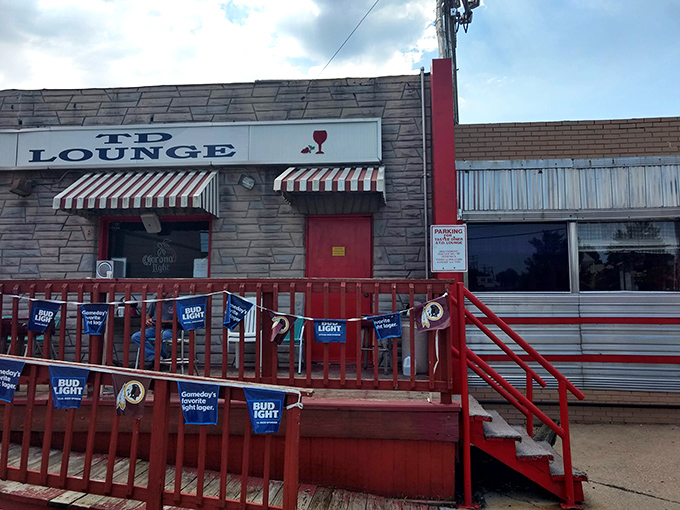 The iconic red steps and railings of Tastee Diner welcome hungry patrons like a culinary red carpet to comfort food royalty.
