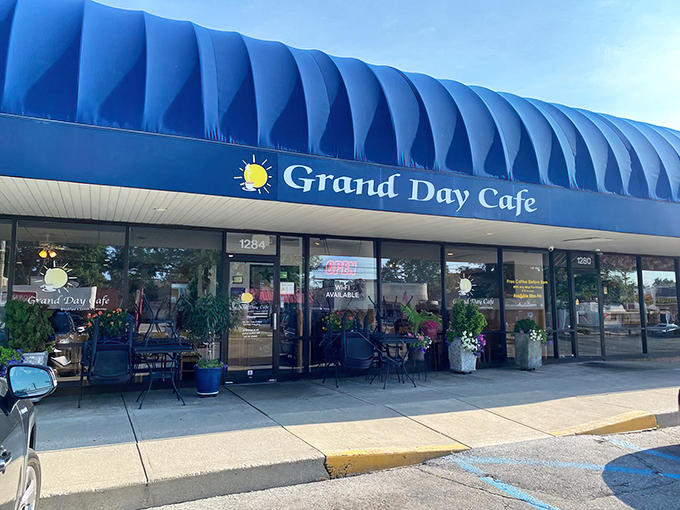 The iconic blue awning of Grand Day Cafe stands out like a beacon for breakfast lovers, promising comfort food that'll make your taste buds do a happy dance.