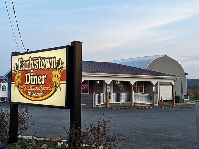 A different angle reveals the diner's charming front porch and illuminated sign&mdash;like finding the Emerald City of breakfast at the end of a country road.