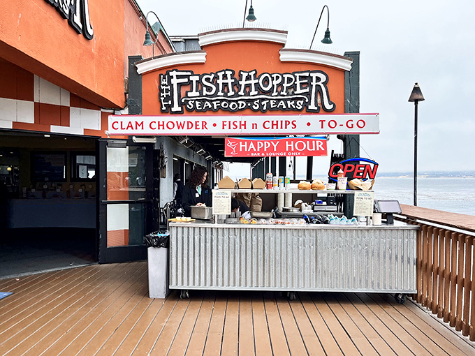 The vibrant orange facade of Fish Hopper stands like a cheerful sentinel on Cannery Row, promising seafood treasures with a side of Pacific views.
