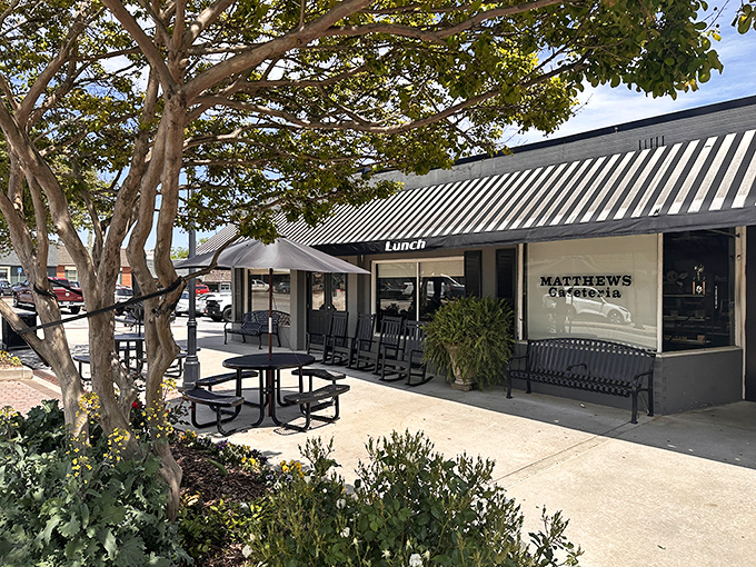 The welcoming storefront of Matthews Cafeteria, where rocking chairs invite you to sit a spell before diving into Southern comfort food heaven.