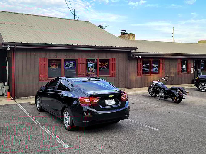 The unassuming wooden exterior with bright red shutters is like finding a treasure map where X marks the spot for comfort food glory.