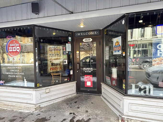 The unassuming entrance to Real Smoq'ed BBQ beckons with promises of smoky delights. That red sign is like a barbecue bat signal for hungry Clevelanders.