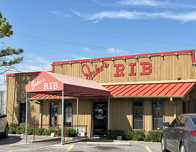 The unassuming wooden exterior of Jake's Rib with its bold red signage promises barbecue greatness without the fancy frills.