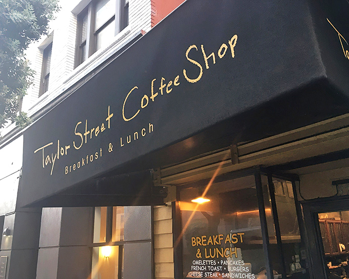 The unassuming black awning with gold lettering promises simple "Breakfast & Lunch" – San Francisco's version of Clark Kent hiding Superman.