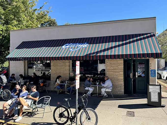 The iconic striped awning of Clary's Cafe beckons like a breakfast lighthouse guiding hungry souls through Savannah's historic district.