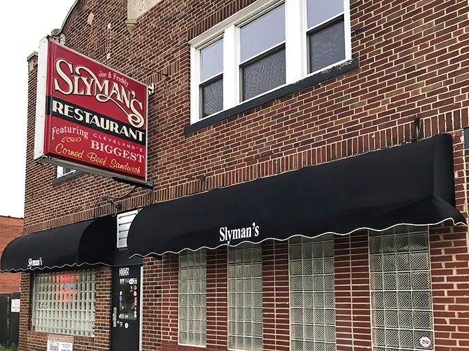 The unassuming brick exterior of Slyman's promises "the BIGGEST Corned Beef Sandwich" &ndash; not just marketing, but a solemn vow to sandwich lovers everywhere.