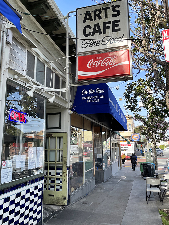 The classic neon "OPEN" sign beckons like an old friend. Art's Cafe's vintage storefront promises authentic diner magic in San Francisco's Inner Sunset.