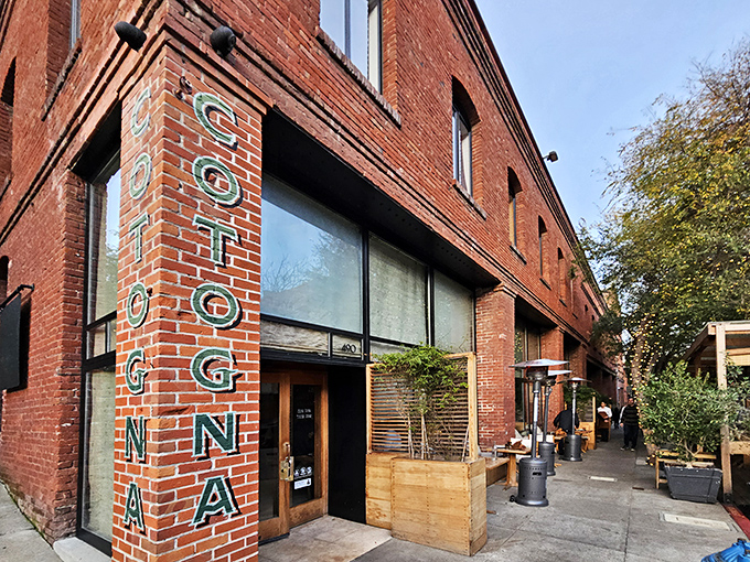 Cotogna's rustic brick exterior with its vertical teal signage stands as an understated invitation to one of San Francisco's most beloved Italian treasures.