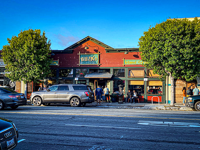The bright red facade of Hula's Island Grill stands out against Monterey's blue sky like a tropical postcard come to life on Lighthouse Avenue.