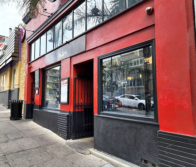 The vibrant red exterior of Brenda's beckons like a culinary lighthouse in San Francisco's Tenderloin, promising soulful delights within.