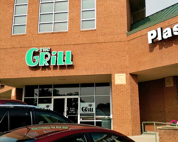 The unassuming brick exterior hides culinary treasures like a food speakeasy. Those green signs might as well say "Deliciousness Ahead."