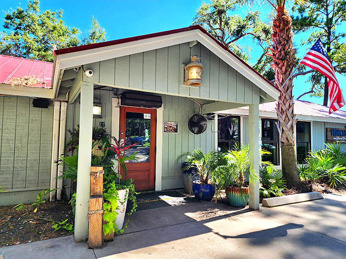 The mint-green clapboard exterior and welcoming front porch say "come on in" like a friendly neighbor with seafood secrets to share.