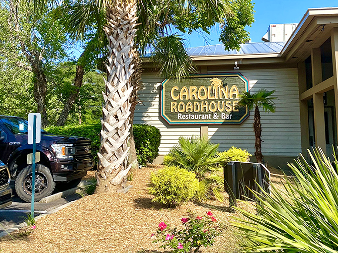 The unassuming entrance to Carolina Roadhouse beckons with tropical palm trees and a classic sign&mdash;culinary treasures often hide in plain sight.