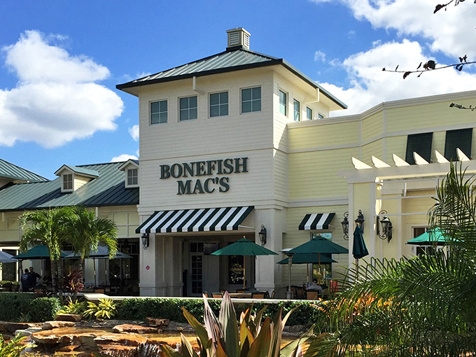 Architectural charm meets tropical paradise. The restaurant's façade perfectly complements the lush landscaping and serene water feature that greets hungry visitors.