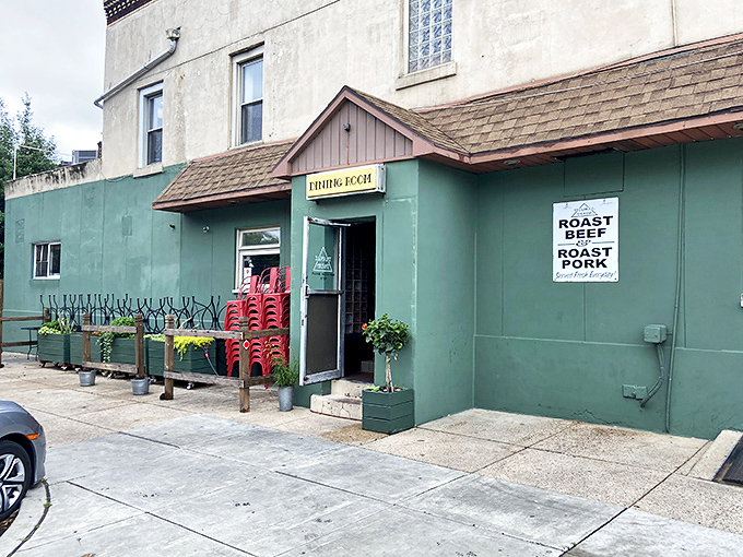 The green facade of Triangle Tavern welcomes hungry visitors with a promise of classic Philly comfort food and that unmistakable neighborhood charm.
