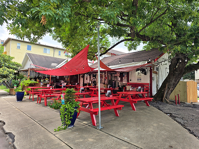 That charming white building with red trim is your beacon to burger paradise in Houston's Montrose neighborhood.