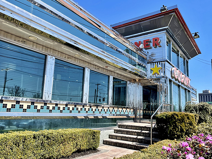 The gleaming chrome exterior of Colony Diner shines like a beacon of breakfast hope on Hempstead Turnpike, promising pancake perfection within those retro walls.