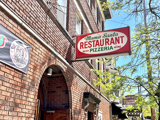 The iconic red sign beckons like an old friend, promising Italian comfort beneath the Cleveland sky. Mama Santa's brick fa&ccedil;ade has witnessed decades of hungry pilgrims.