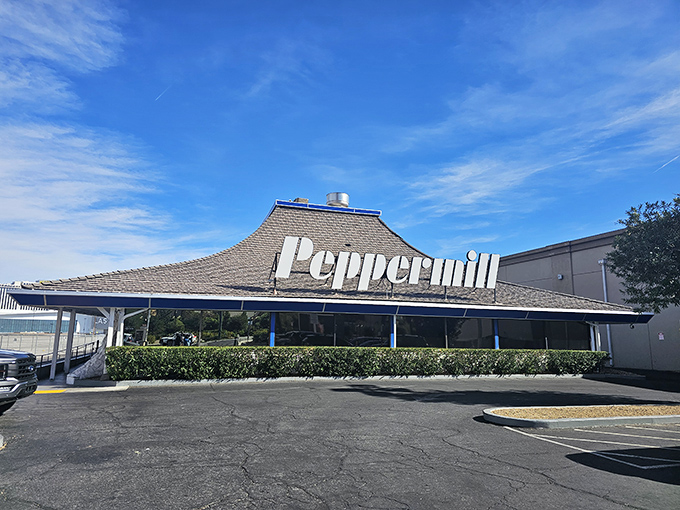 The iconic pagoda-style roof of Peppermill stands like a retro beacon on the Las Vegas Strip, promising comfort food salvation amid the neon wilderness.