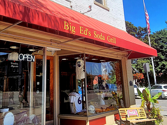 The iconic red awning of Big Ed's beckons like a time machine to simpler days, when soda fountains ruled and conversations happened face-to-face.