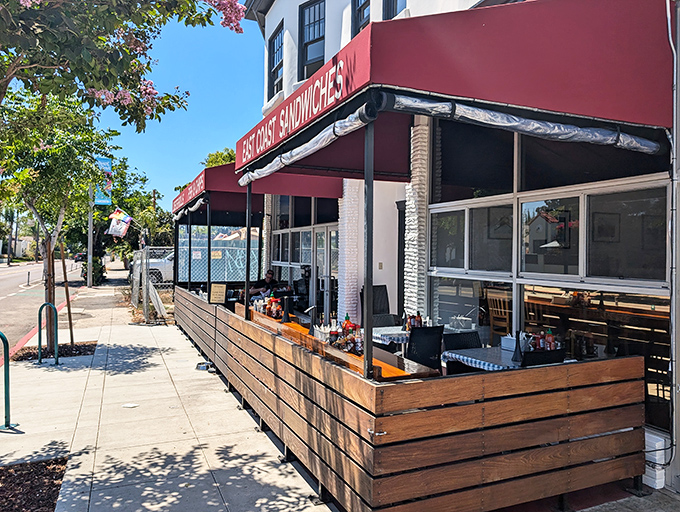The unassuming storefront with its red awning and wooden patio railing is like a secret handshake among San Diego seafood lovers—modest exterior, extraordinary flavors within.