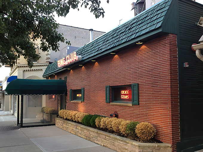 Bathed in evening light, The Pine Club's classic exterior has welcomed generations of steak lovers through its doors, a timeless beacon for those seeking beef perfection.