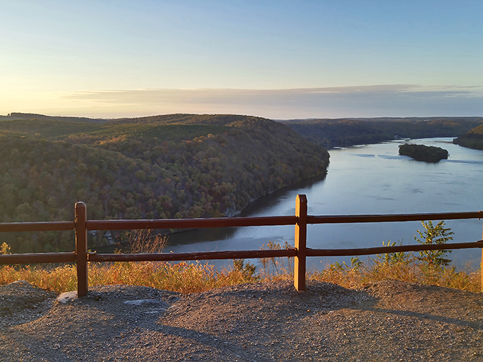 Nature's infinity pool! The Susquehanna River curves majestically below as golden hour transforms this wooden railing into the world's most perfect frame.