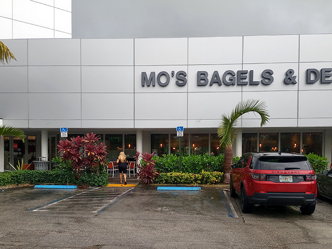 The unassuming exterior of Mo's Bagels & Deli in Aventura &ndash; where Florida sunshine meets New York deli tradition in a strip mall paradise.