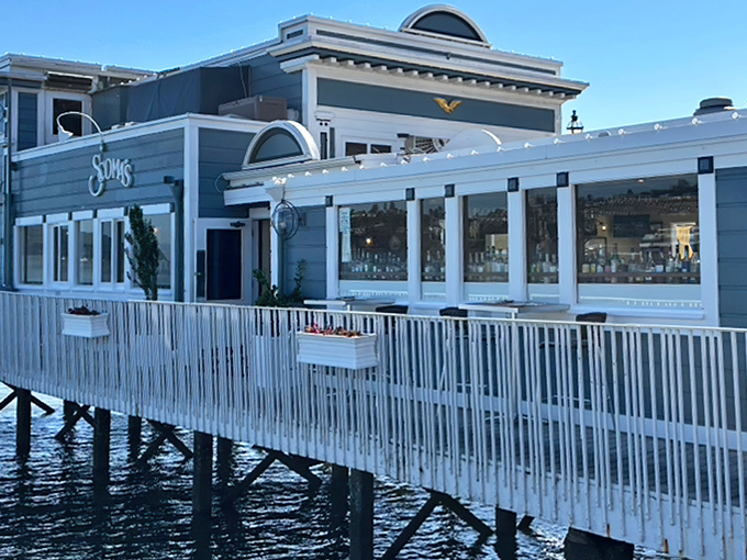 The restaurant perches dramatically over the water, its white-railed walkway inviting you into a seafood sanctuary where bay views come standard.