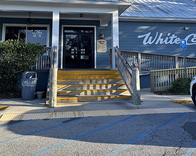 Those yellow steps aren't just stairs &ndash; they're your gateway to seafood paradise. The blue exterior of White Cap welcomes hungry souls with coastal charm.