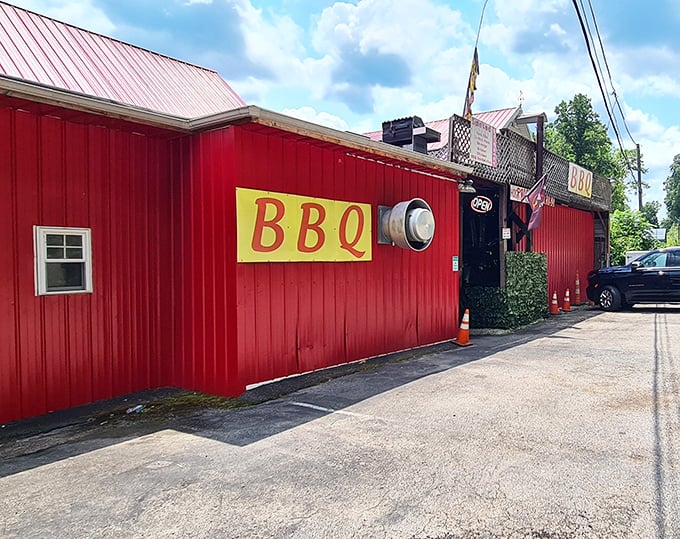 The bright red exterior of Rollin Smoke BBQ stands like a beacon for hungry travelers. No fancy frills needed when the food does all the talking.