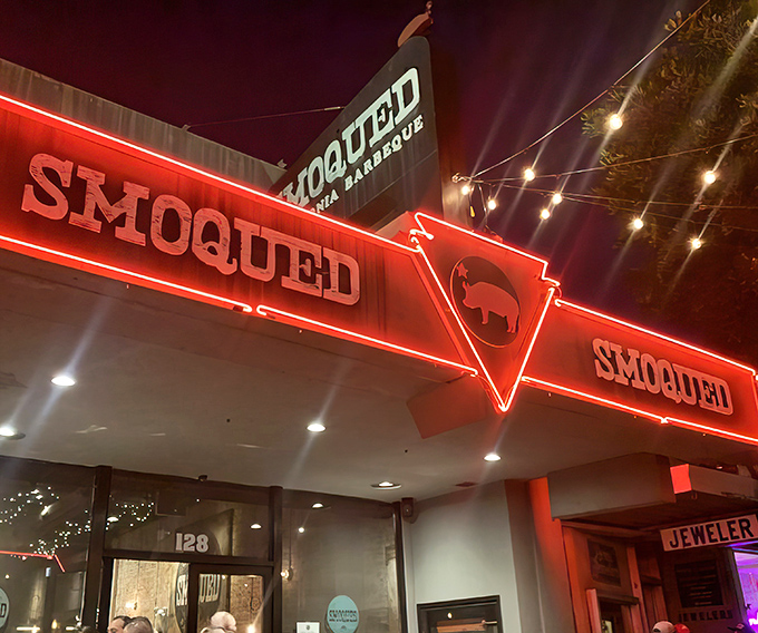 The neon glow of Smoqued's sign beckons like a barbecue lighthouse, guiding hungry souls through the night to smoky salvation.