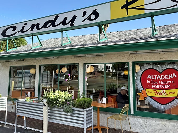 The iconic green-trimmed exterior of Cindy's beckons hungry diners with its vintage charm and promise of classic American comfort food.