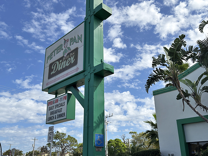 The mint-green sign stands like a culinary lighthouse against Florida's blue sky, beckoning hungry travelers to this Oakland Park institution.