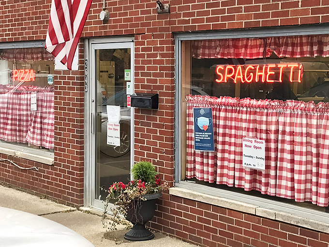 The classic brick exterior with red-checkered curtains and neon signs isn't trying to be trendy&mdash;it's the real deal, a time capsule of authentic Italian-American dining.