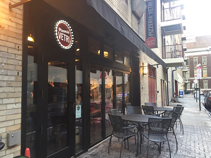 The iconic red circular sign of Pizzeria Vetri beckons hungry Philadelphians like a pizza-shaped lighthouse guiding ships to delicious shores.