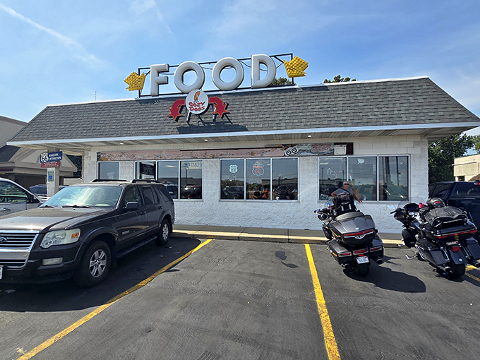 The humble white exterior with its cheerful "FOOD" sign promises no frills, just thrills for your taste buds. Route 66 magic awaits.