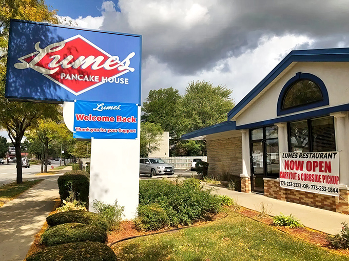 The iconic red diamond sign of Lumes Pancake House stands as a breakfast beacon, promising morning salvation to hungry Chicagoans.