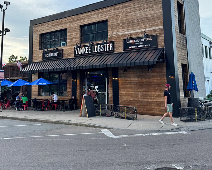 The wooden façade of Yankee Lobster stands like a beacon of seafood salvation in Boston's Seaport District, promising maritime treasures within.