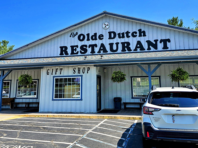 The classic white clapboard exterior of Olde Dutch Restaurant stands like a beacon of comfort food in Logan, Ohio's rolling hills.